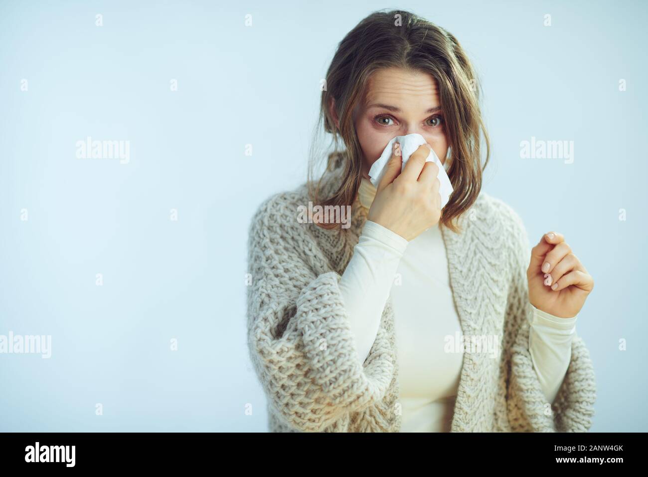 Portrait of sick modern female in roll neck sweater and cardigan with ...