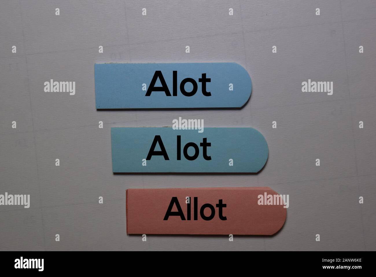 Alot, a lot, Allot write on a sticky note isolated on office desk ...