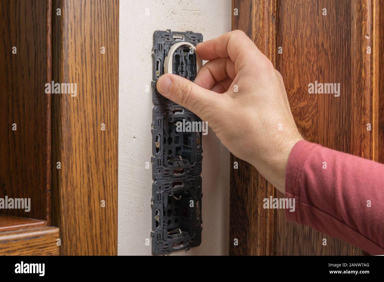 Wall socket . The process of installing an electrical outlet Stock ...