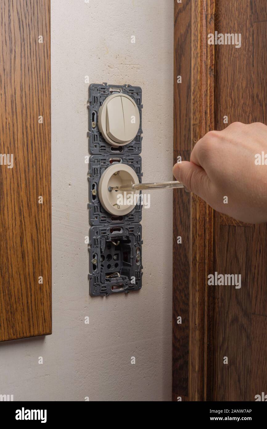 Wall socket . The process of installing an electrical outlet Stock ...
