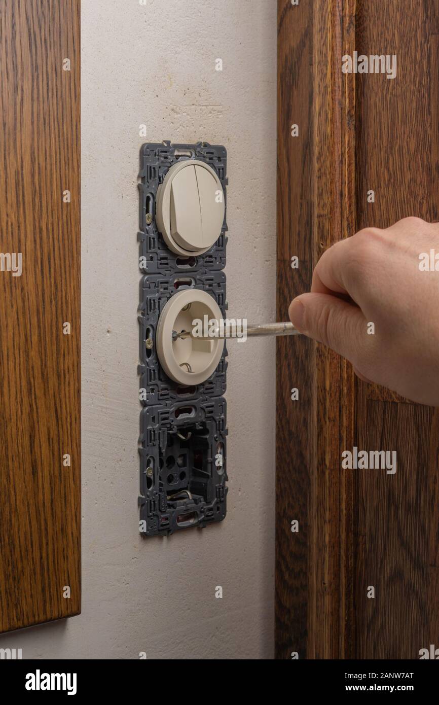 Wall socket . The process of installing an electrical outlet Stock ...