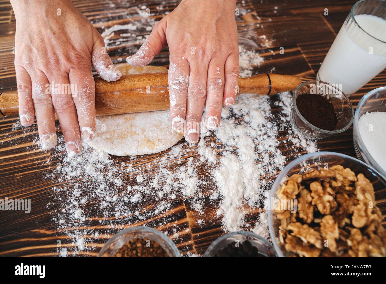Woman is rolling pin on dough in kitchen, dough recipe ingredients and ...