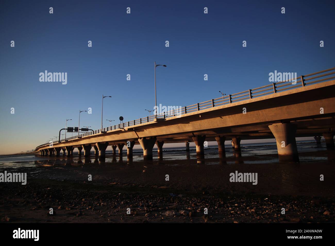 Causeway across Arabian Gulf sea at sunset Stock Photo - Alamy
