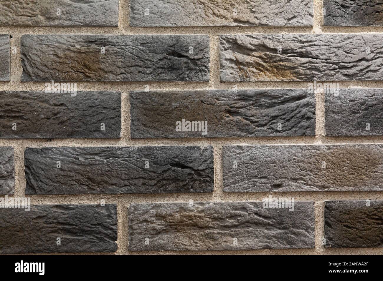 close-up of masonry wall with ceramic cladding brick dark gray-brown ...