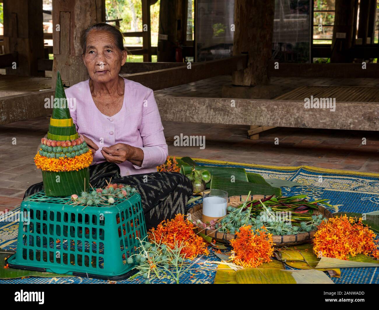 Old woman making sacrificial religious offering festival decorations ...