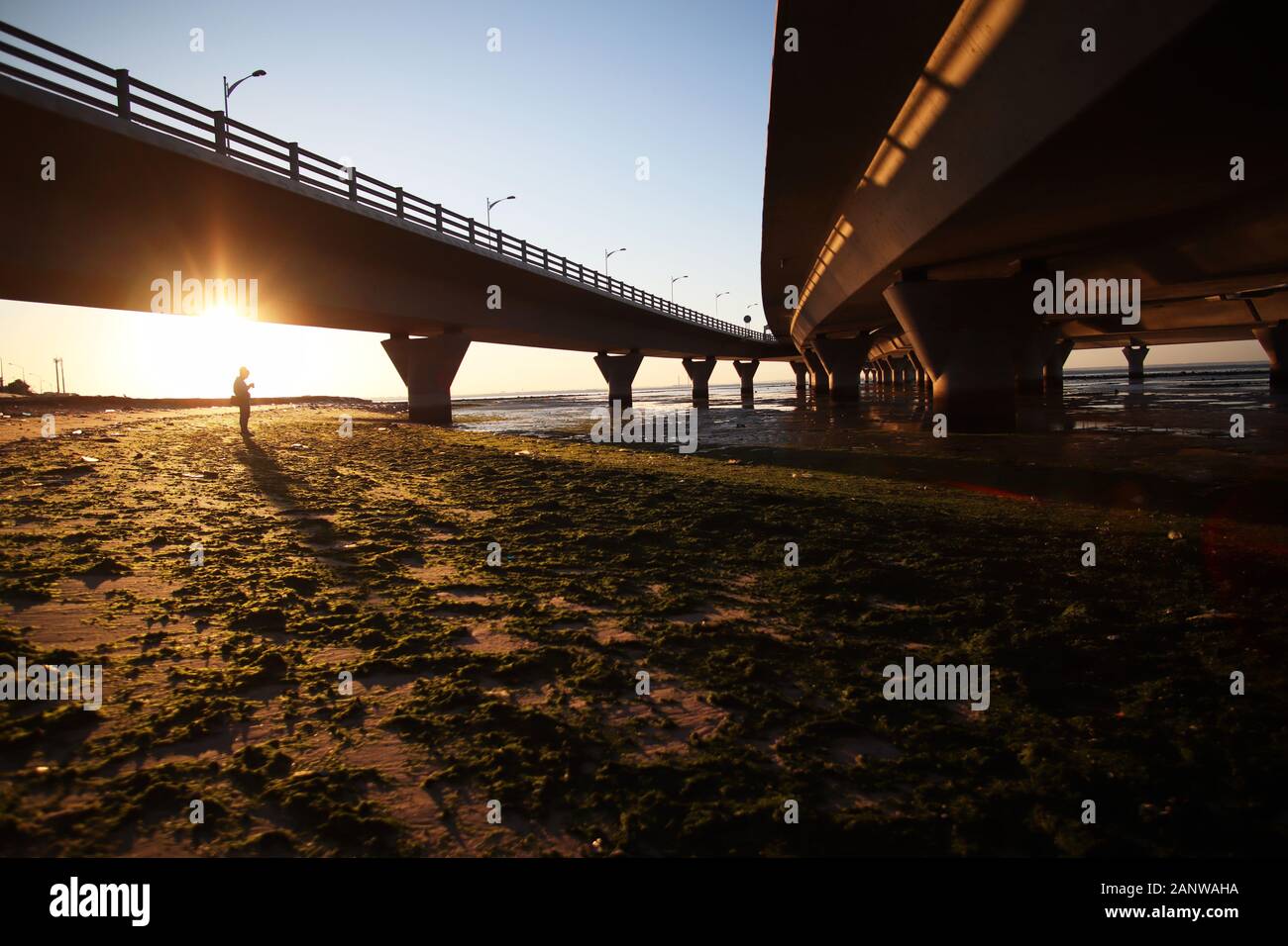 Causeway across Arabian Gulf sea at sunset Stock Photo - Alamy