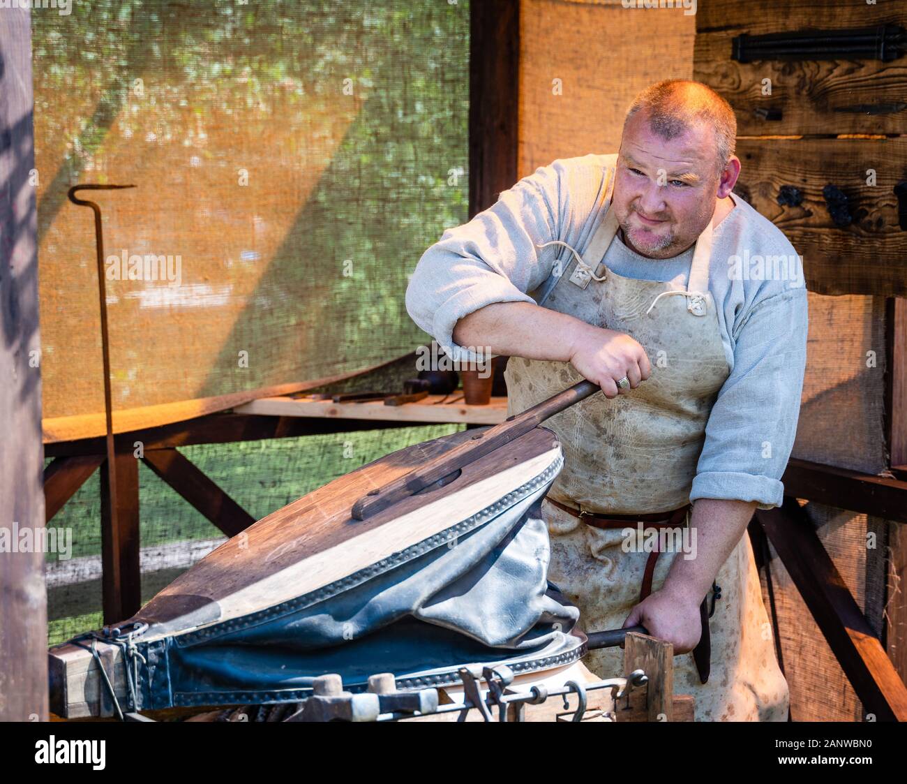 Forge in the open air during the living history festival. A large man ...