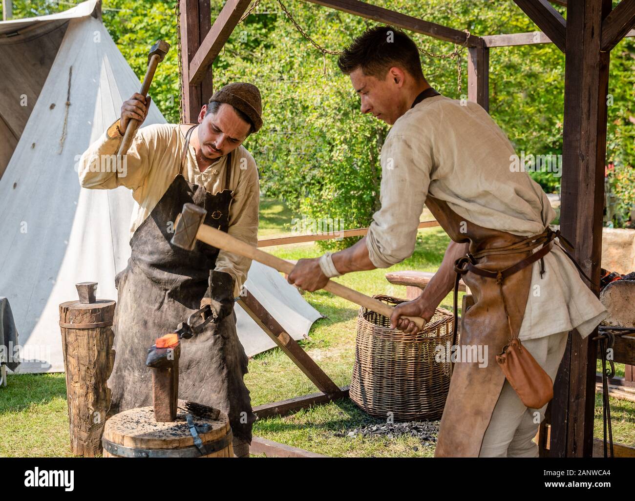 Master and apprentice forge. Forge in the open air during the living ...