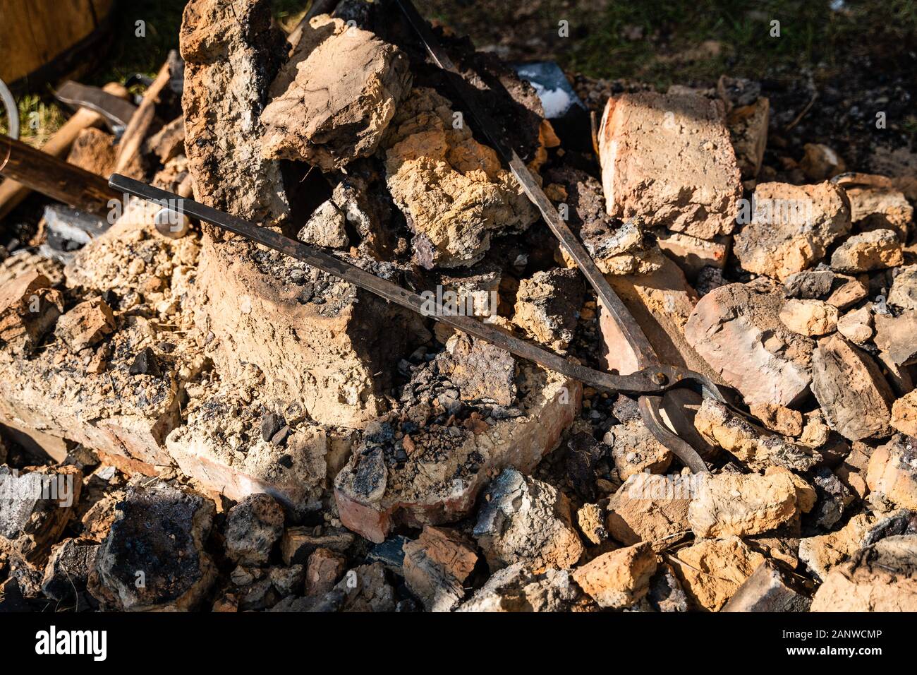 An open-air forge during an ancient tool mites on a heap of scale ...