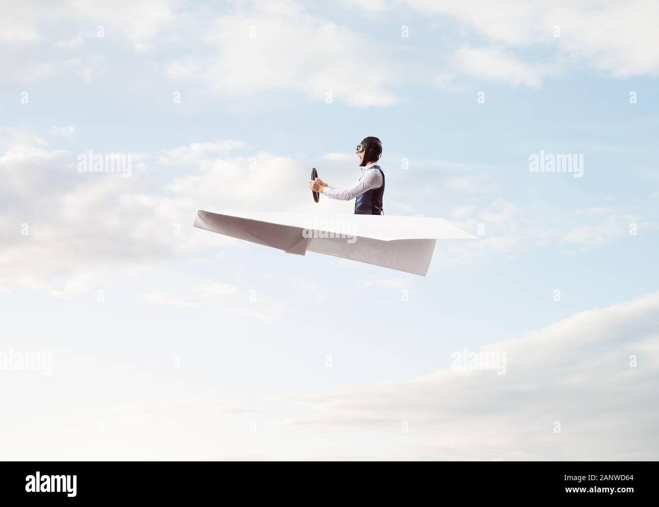 Pilot in leather helmet driving paper plane Stock Photo - Alamy