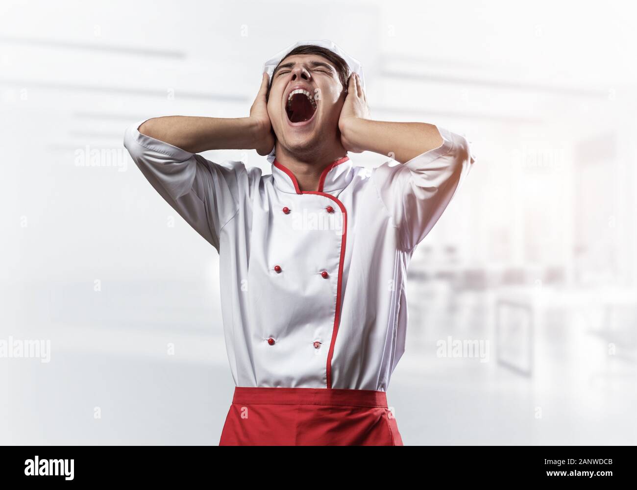 Young male chef screaming in shock and horror Stock Photo - Alamy