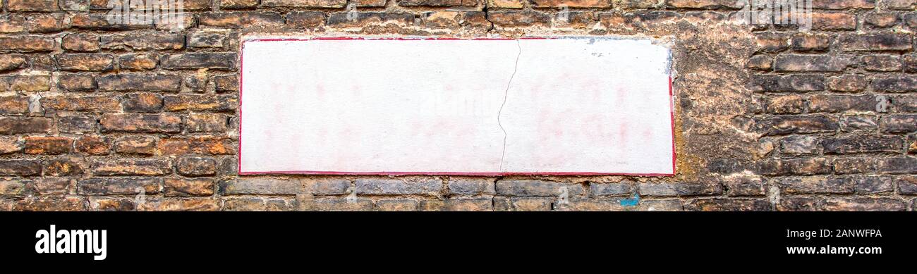 Blank white street sign board panel on brick wall Stock Photo - Alamy