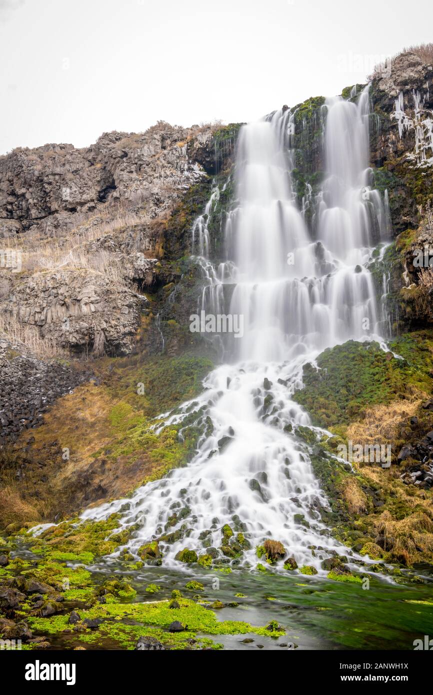 River flows over a cliff forming a large waterfall Stock Photo - Alamy
