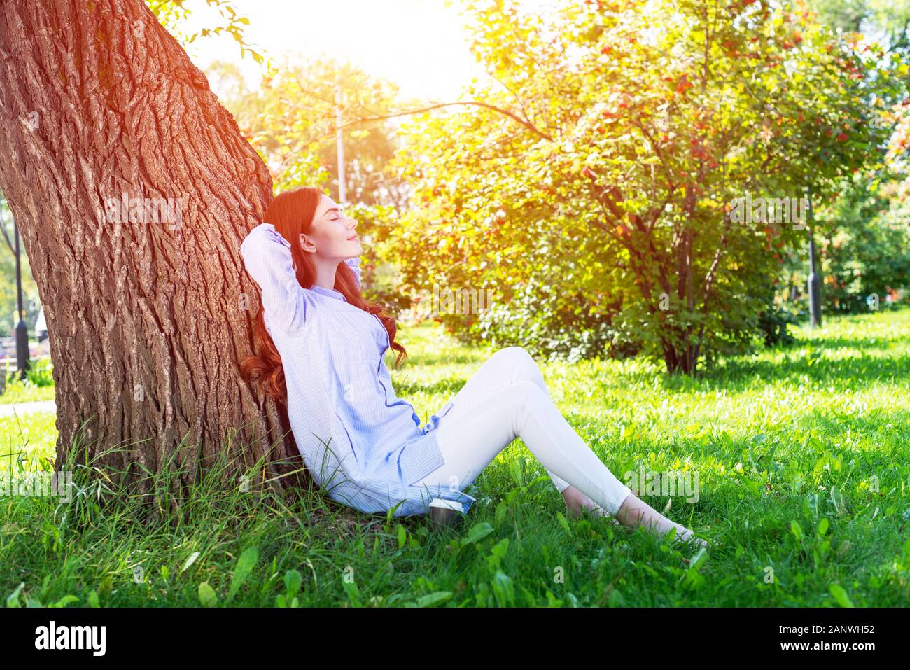 One woman sit against tree hi-res stock photography and images - Alamy