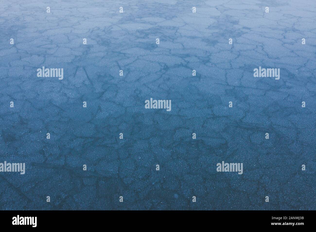 Frozen lake surface, deep blue color and with interesting pattern Stock ...
