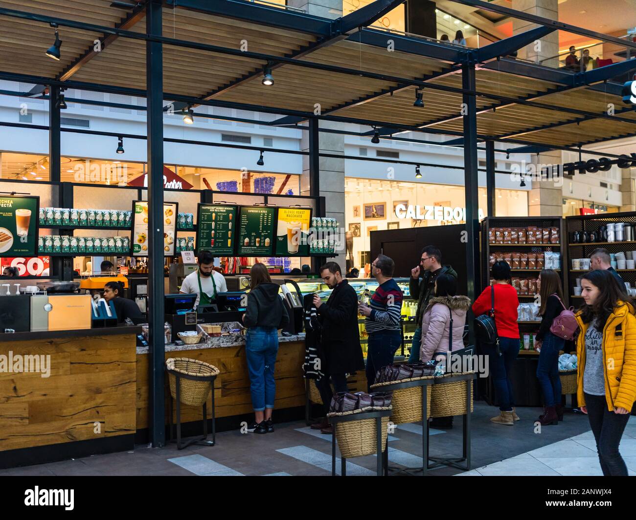 People sitting, waiting in line and working at the Starbucks at AFI ...