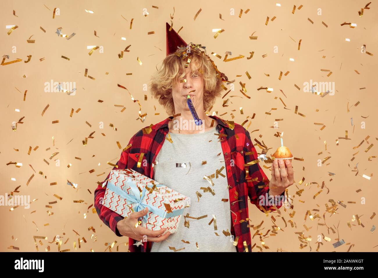 Young man celebrating birthday on party with confetti Stock Photo - Alamy