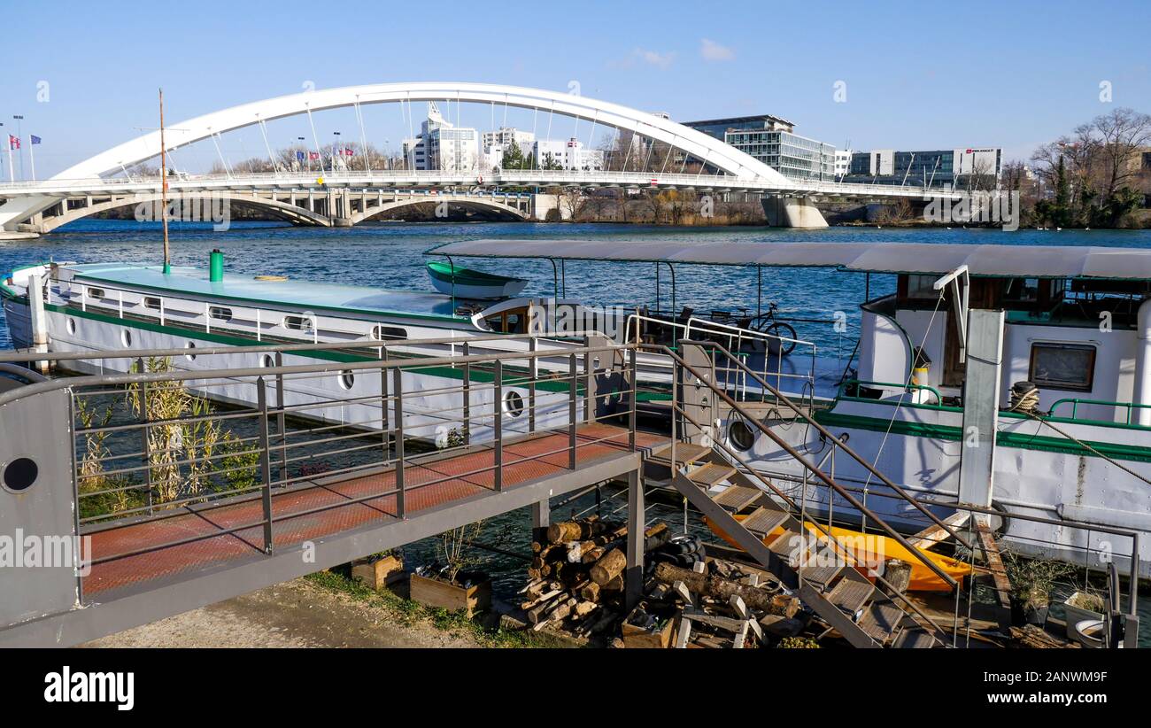 Barges laying at quay along the Rhone river bank at foot of Confluences ...