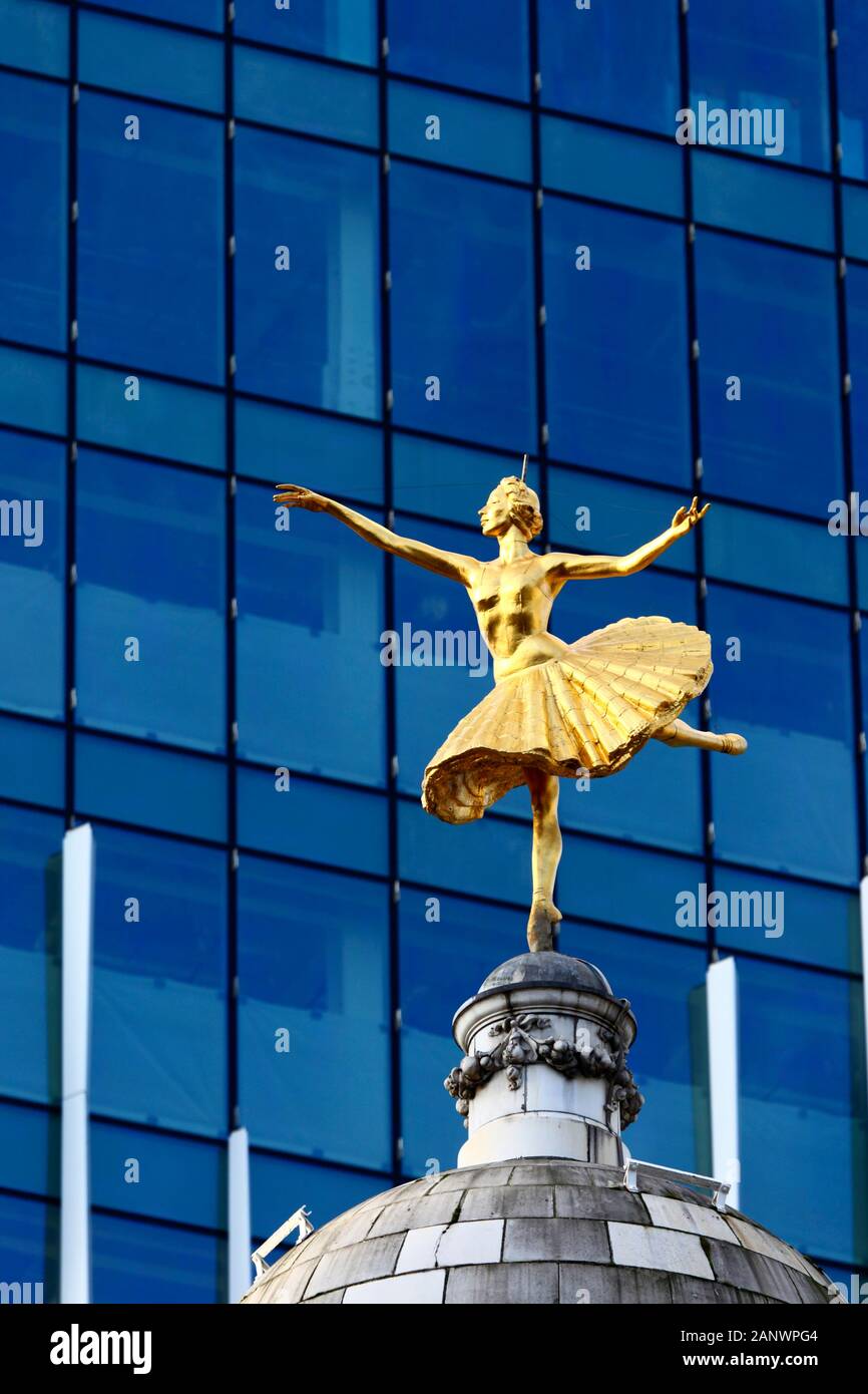 Statue of Russian ballerina Anna Pavlova on top of the dome of Victoria Palace Theatre and glass ...