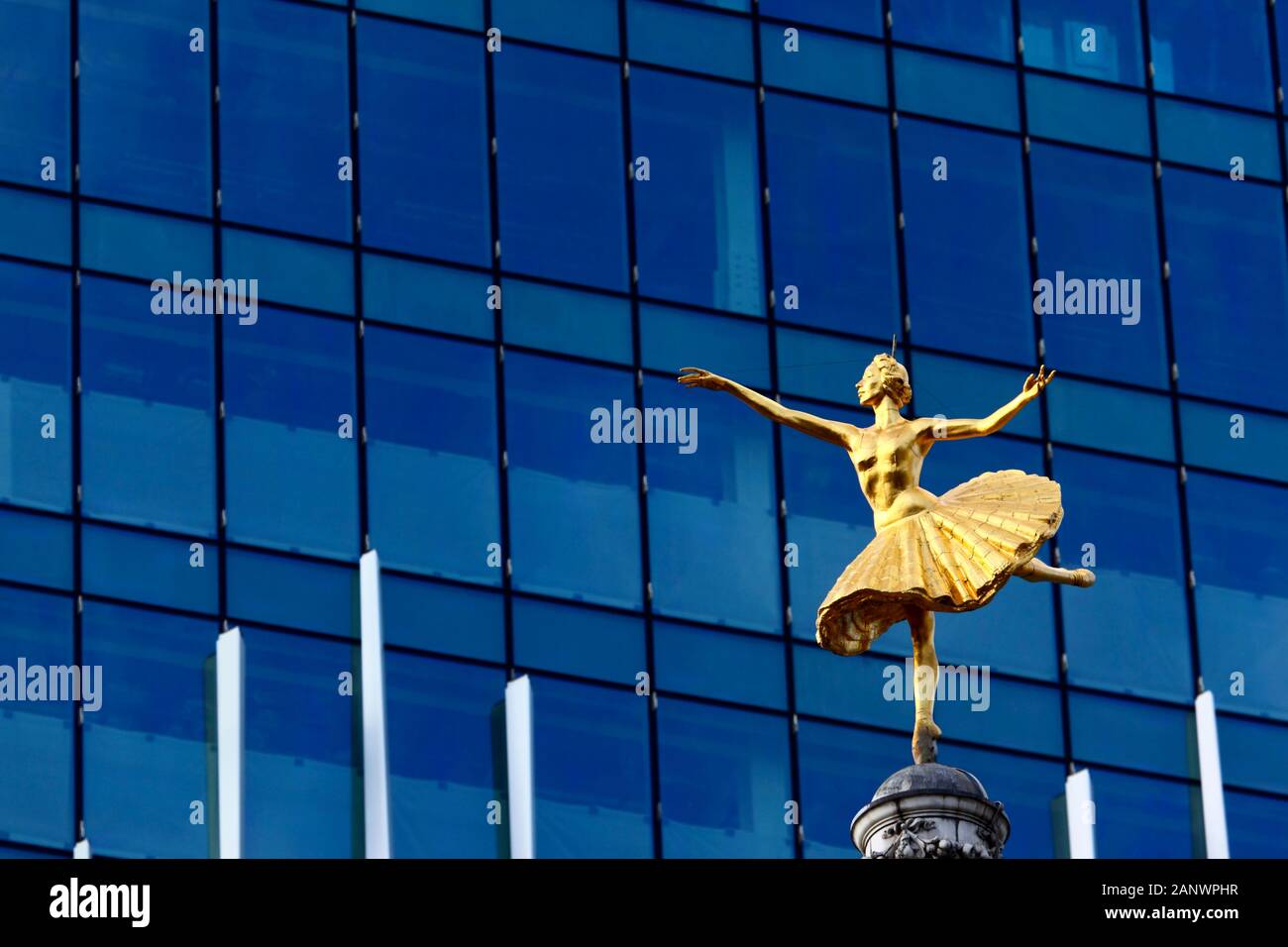 Statue of Russian ballerina Anna Pavlova on top of the dome of Victoria Palace Theatre and glass ...