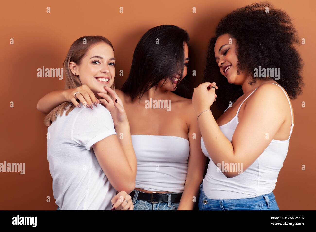 young pretty asian, caucasian, afro woman posing cheerful together on ...