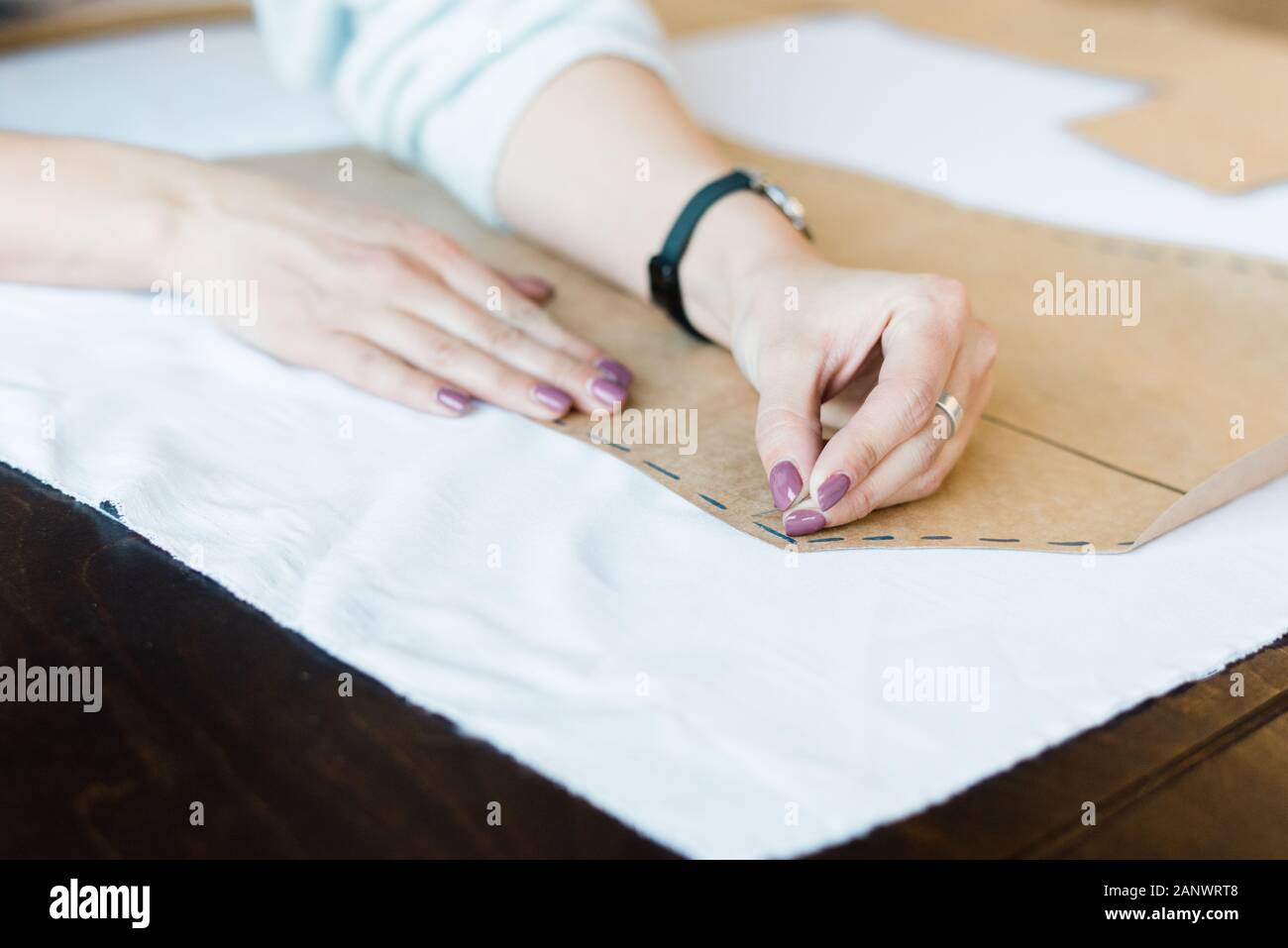 Attaching sewing pattern to fabric Stock Photo - Alamy