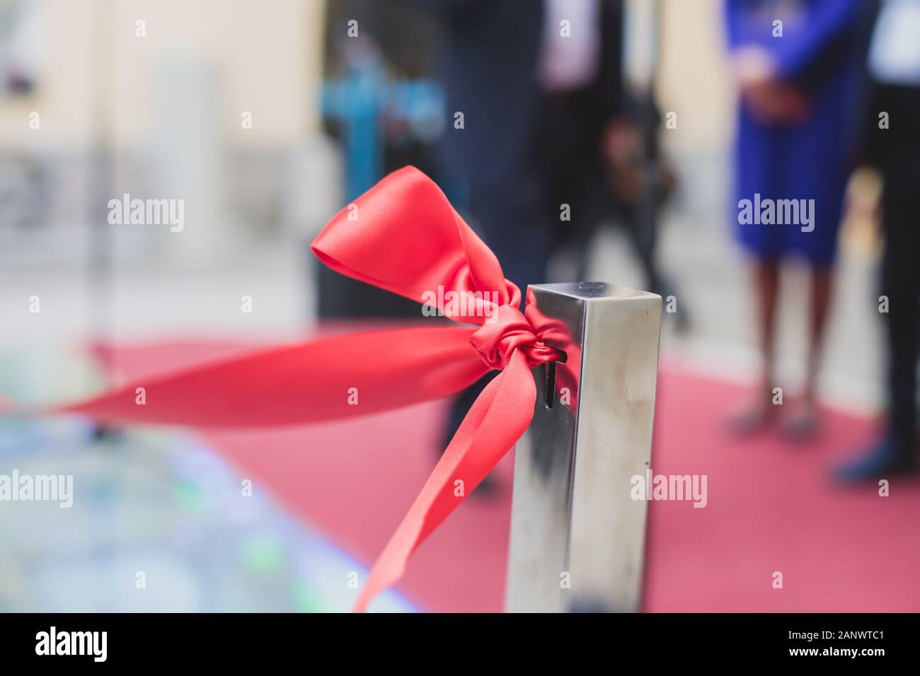 Process of cutting the red ribbon during the grand opening of the new ...