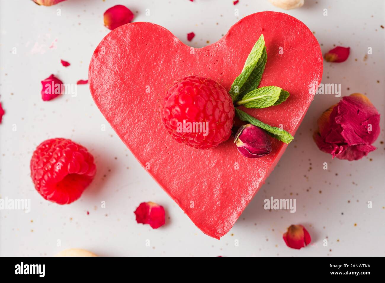 heart shaped red raw vegan cake with fresh raspberries, mint and dried ...