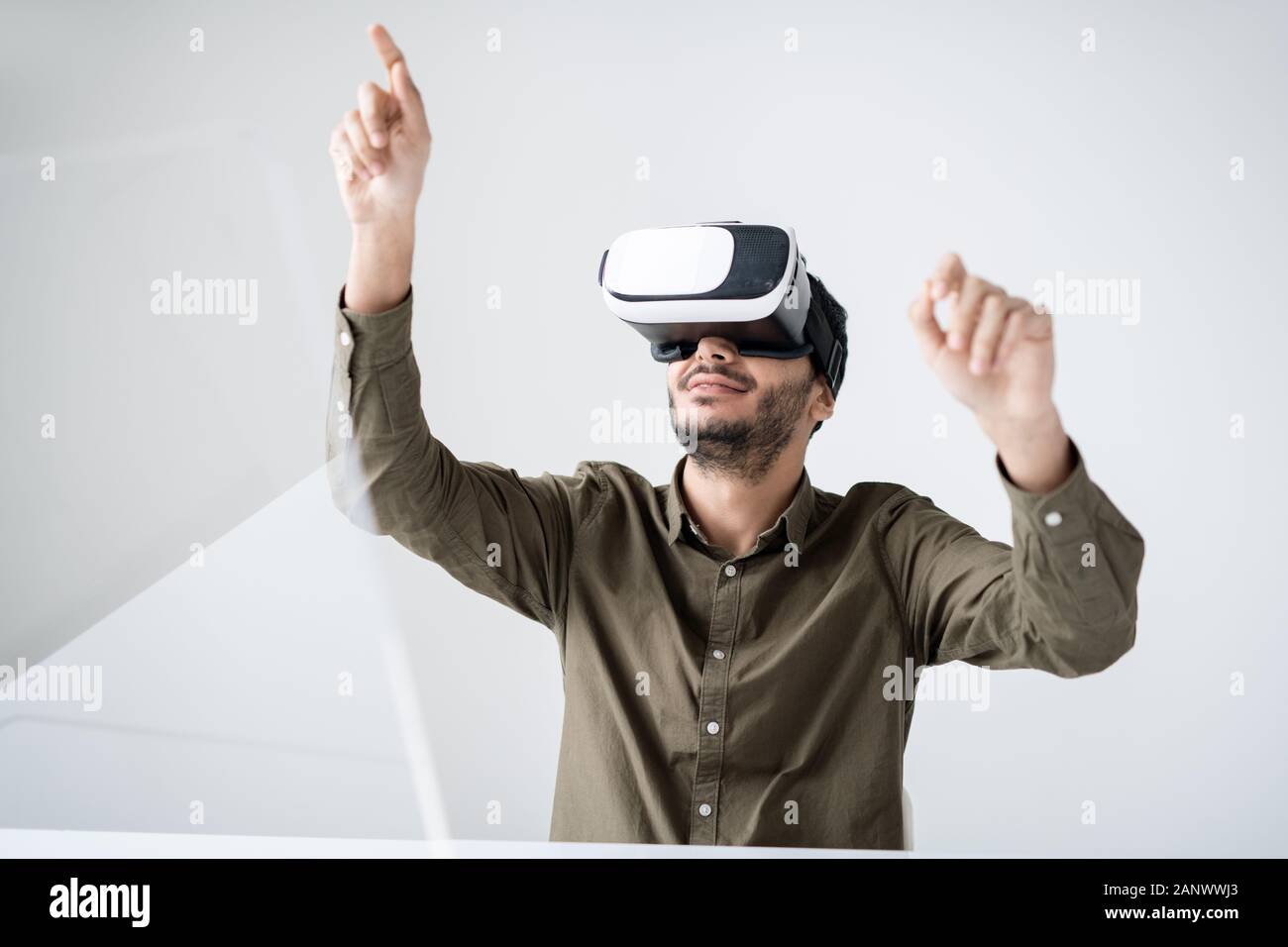 Young contemporary man in vr headset pointing at virtual display Stock ...