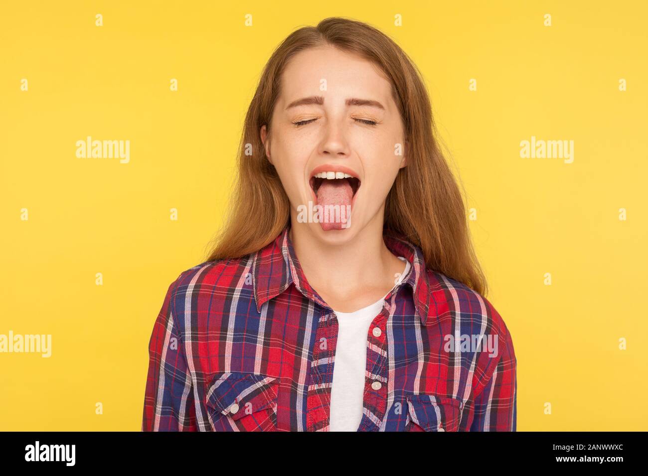Portrait of naughty disobedient ginger girl in casual shirt standing ...