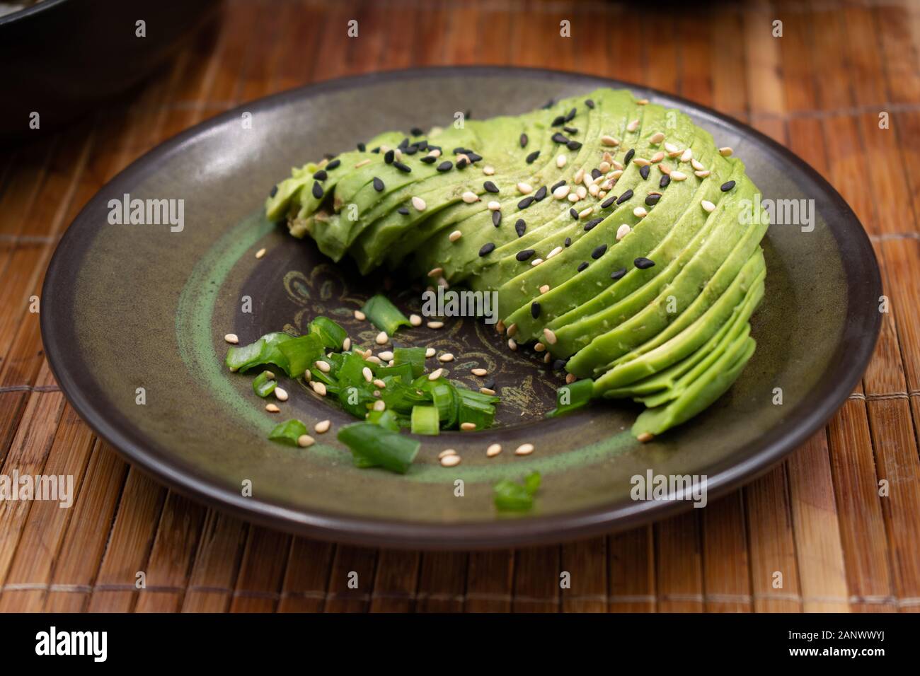 Sliced avocado and sesame seeds Stock Photo - Alamy