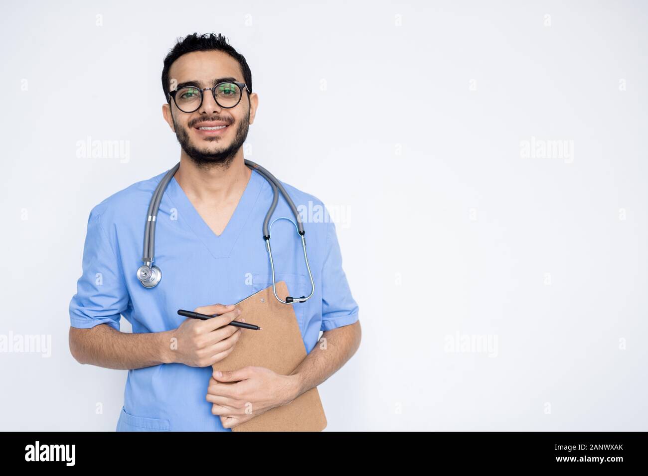 Smiling male clinician with stethoscope holding document with ...