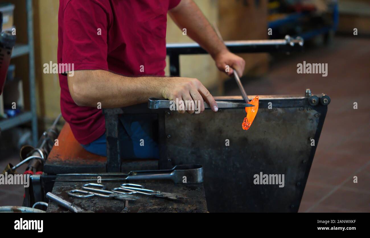 glass blowing art. Glass artist, are created by inserting the glass ...