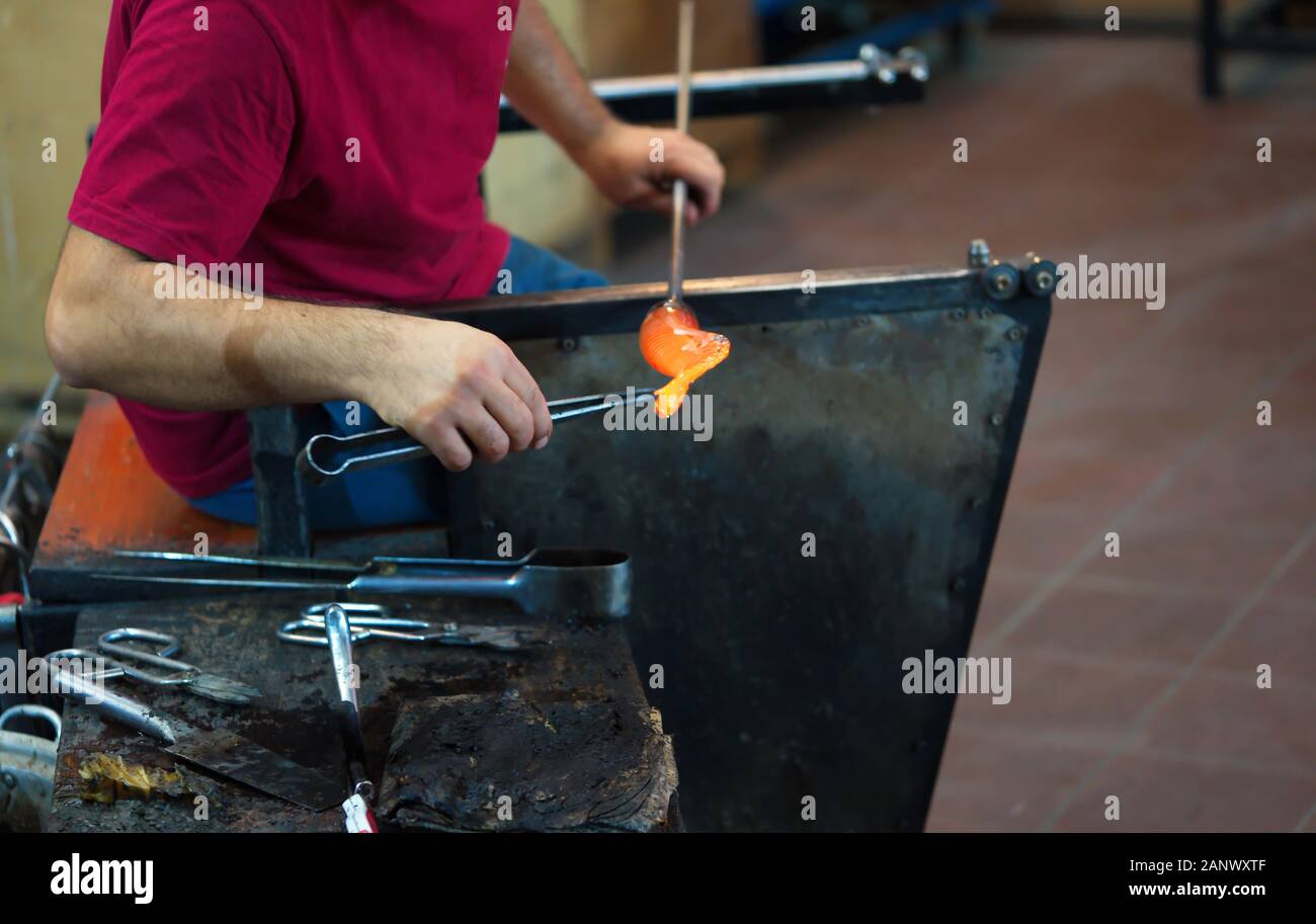 glass blowing art. Glass artist, are created by inserting the glass ...