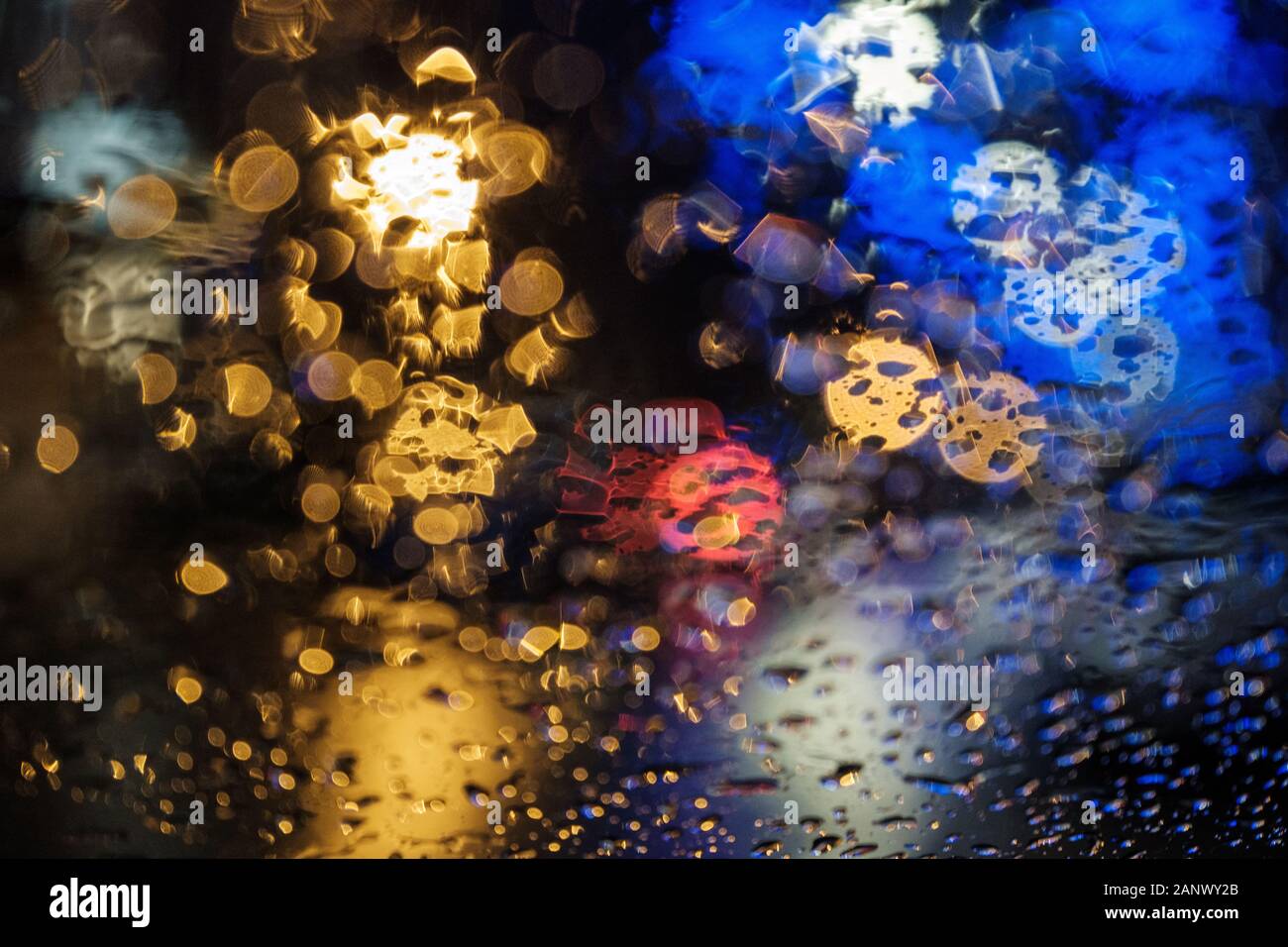 Wet the window with the background of the night city with colored ...