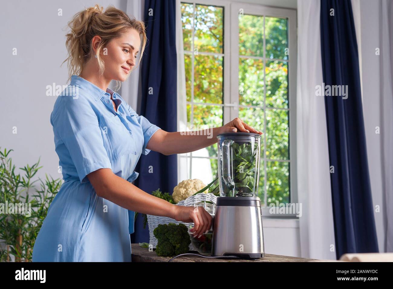 Woman turning on blender making hi-res stock photography and images - Alamy
