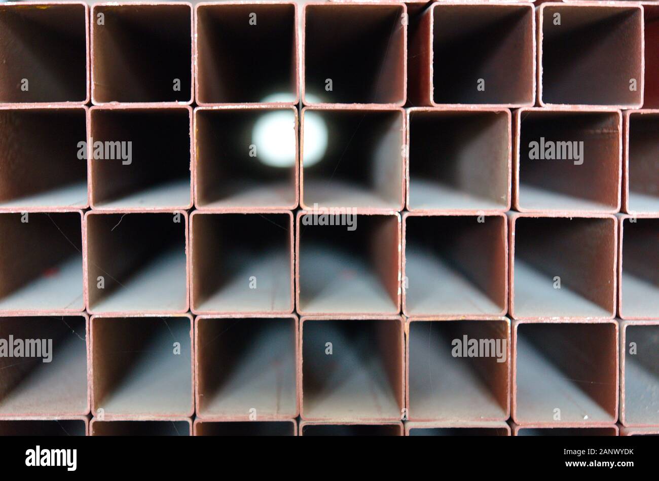 square section iron, steel profile stack background Stock Photo - Alamy