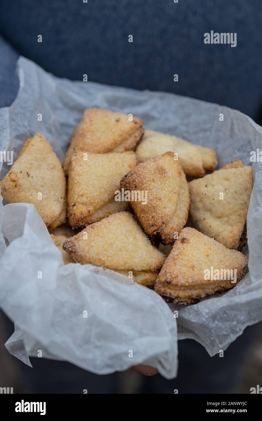 Cottage cheese shortbread triangles on white parchment on an old dark ...