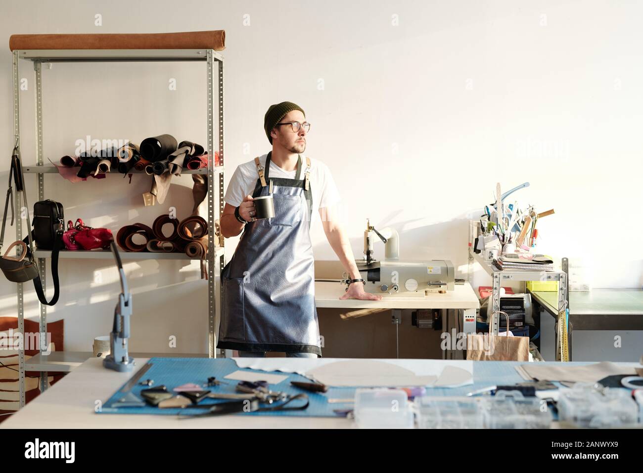 Taking break in leather workshop Stock Photo - Alamy