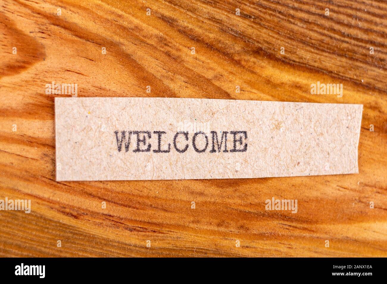 The word "welcome" typed. The inscription on a gray sheet of pappier ...