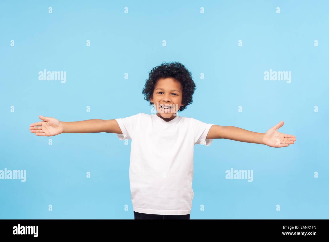 Let's hug. Portrait of friendly hospitable little boy with curls in ...
