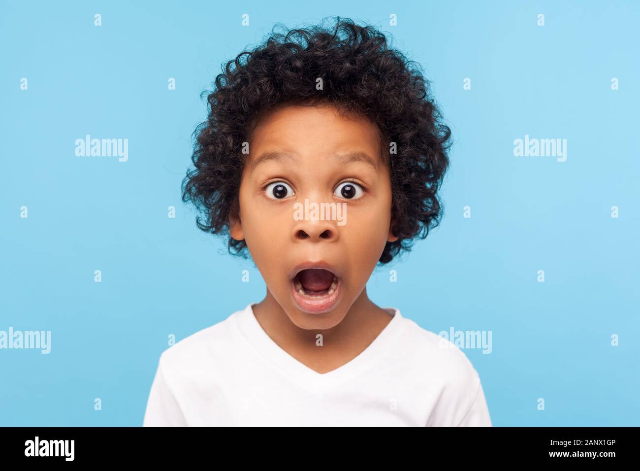 Wow, unbelievable! Portrait of funny amazed little boy looking at ...