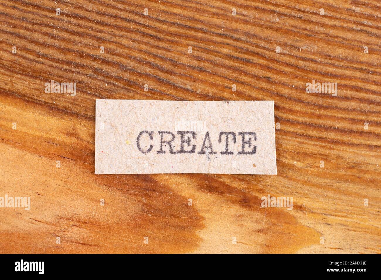 The word "create" typed. The inscription on a gray sheet of pappier ...
