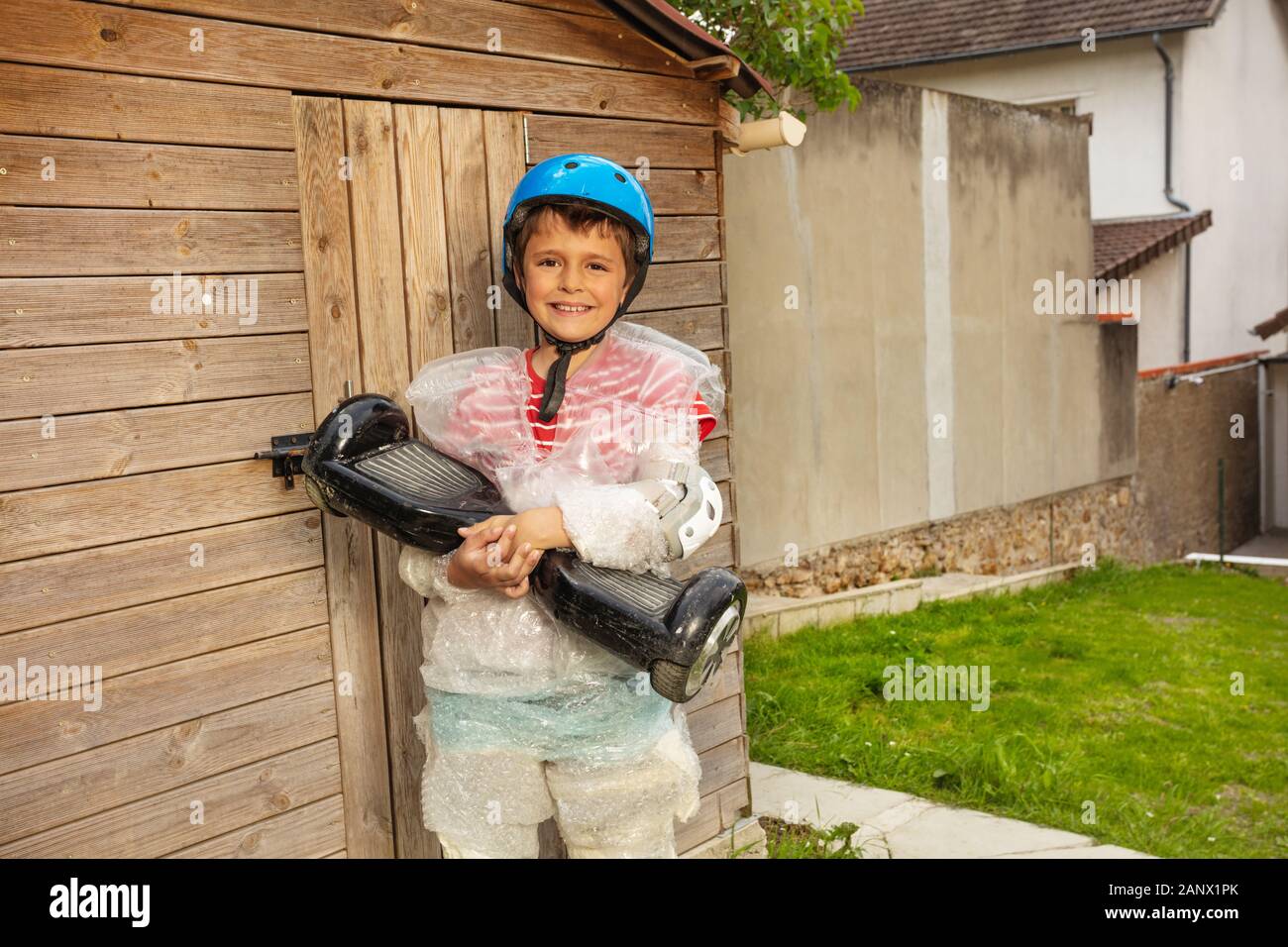 Little child kid with hoverboard and overprotective mother keeping a ...
