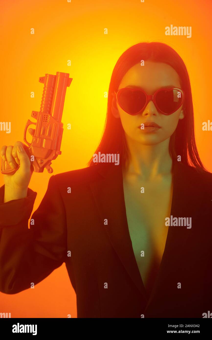 Cruel girl with gun Stock Photo - Alamy