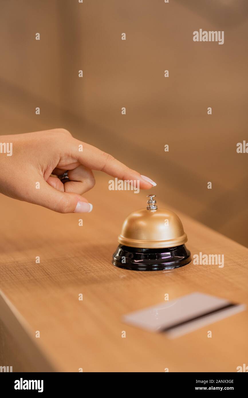 Hand of young contemporary businesswoman going to press call button on ...