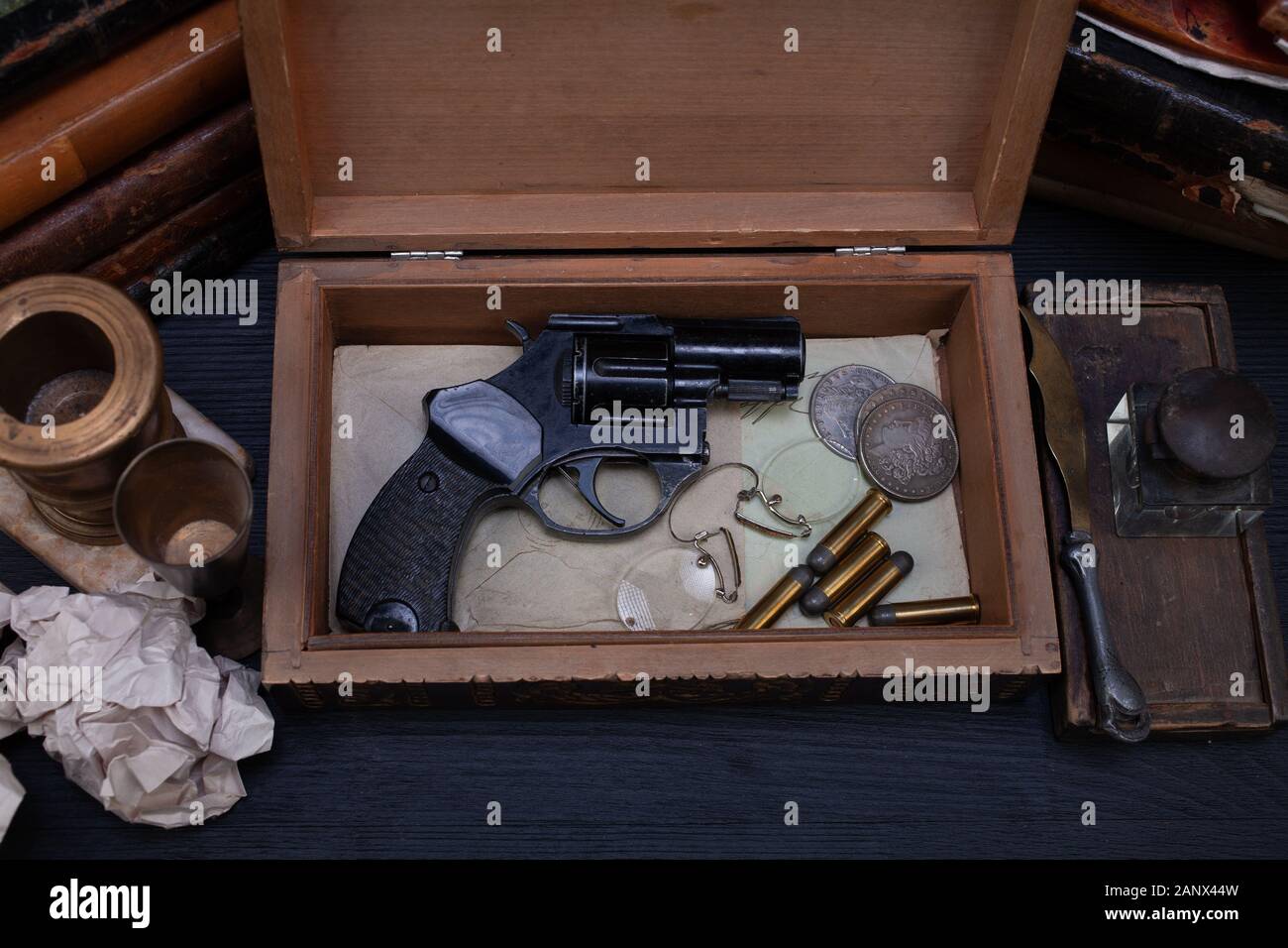 Memorabilia - old retro vintage revolver gun with ammunitions in wooden ...