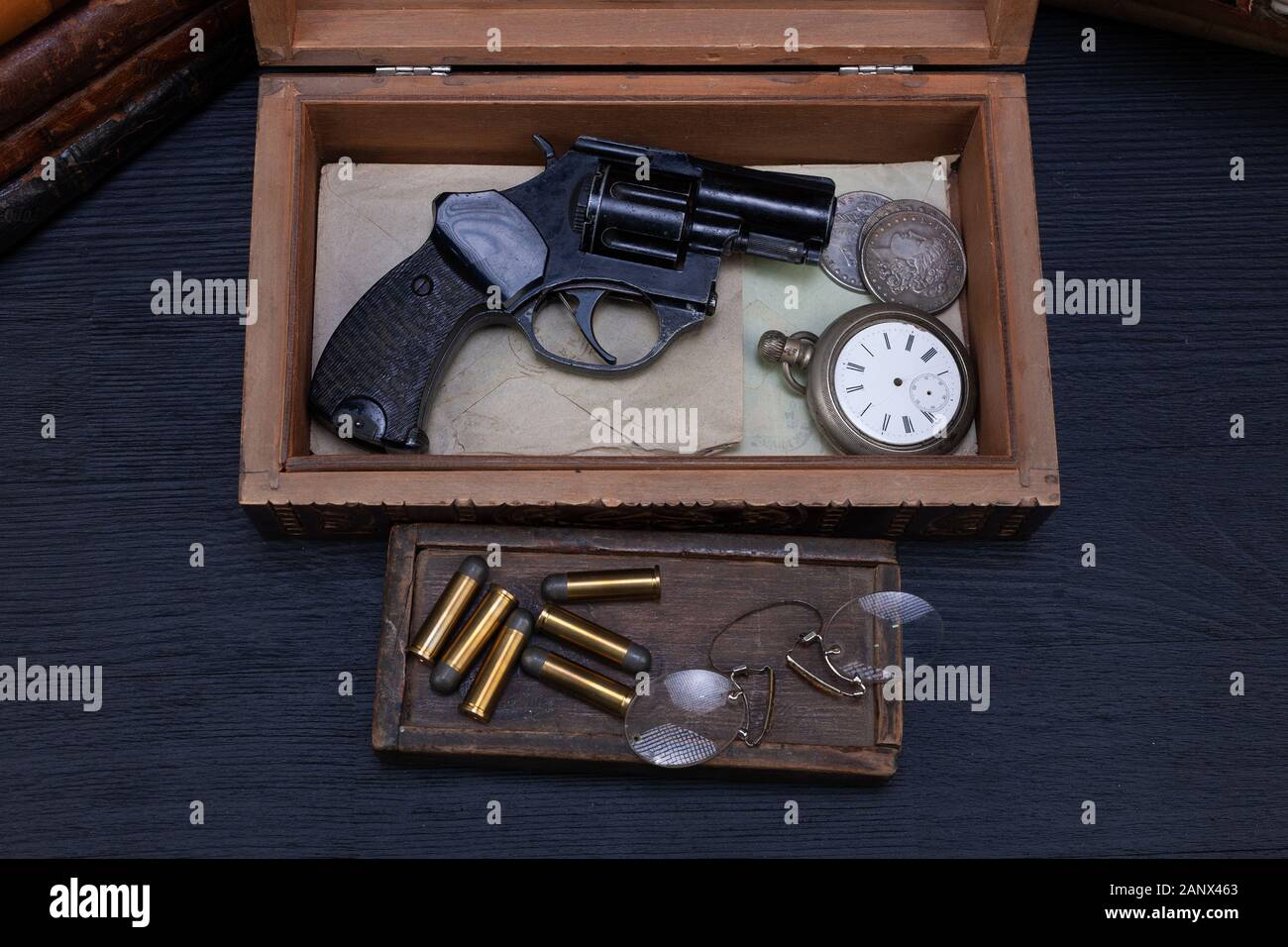 Memorabilia - old retro vintage revolver gun with ammunitions in wooden ...