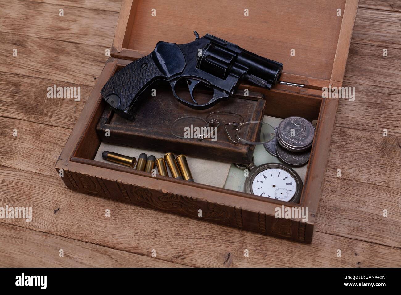 Memorabilia - old retro vintage revolver gun with ammunitions in wooden ...