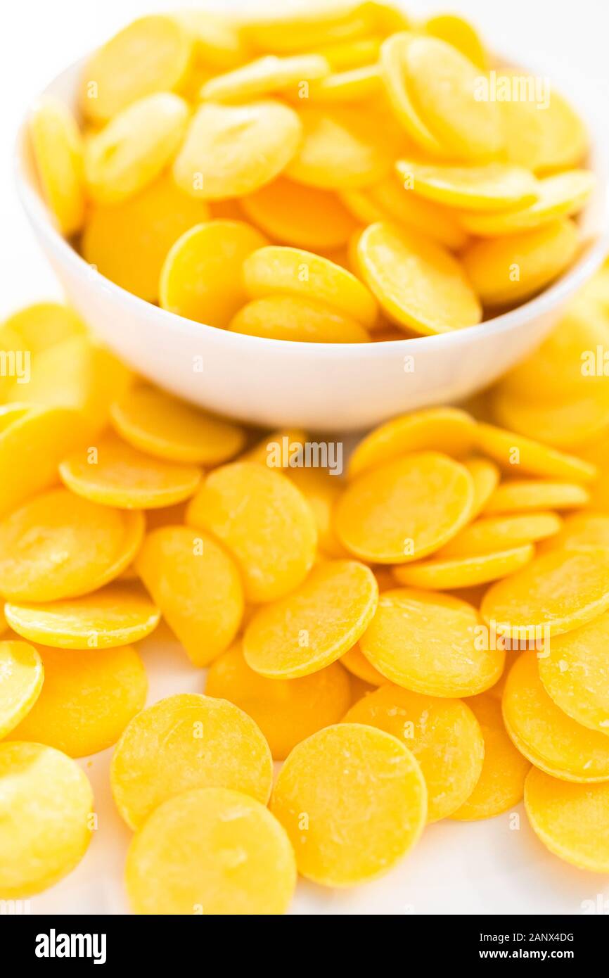 Yellow round chocolate chips for melting chocolate shapes Stock Photo ...